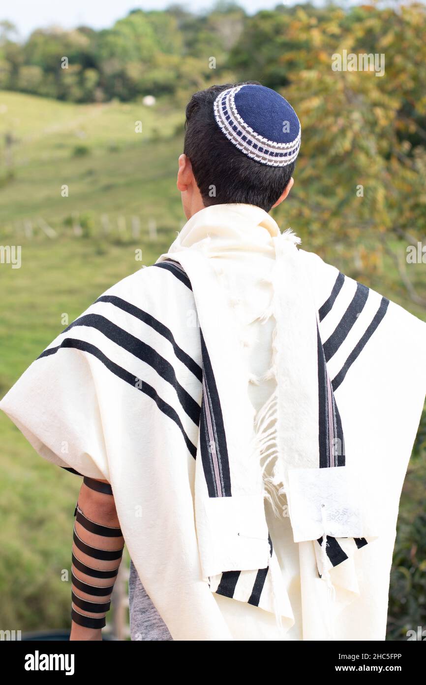 Vertical photo. Jewish man praying with talit, kippah and tefillin in ...