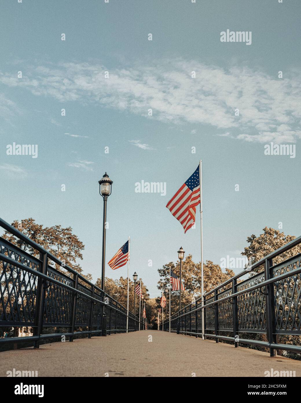 Pedestrian bridge lined with American flags on poles Stock Photo - Alamy
