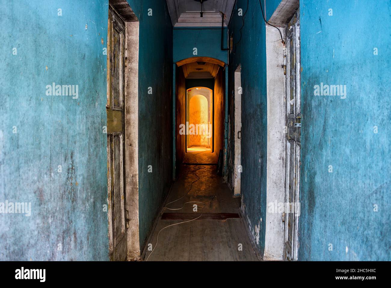 Long empty corridor with blue walls in an old building Stock Photo - Alamy