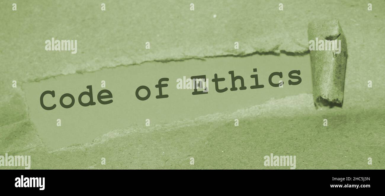Text appearing behind torn brown envelop - Code of ethics Stock Photo ...