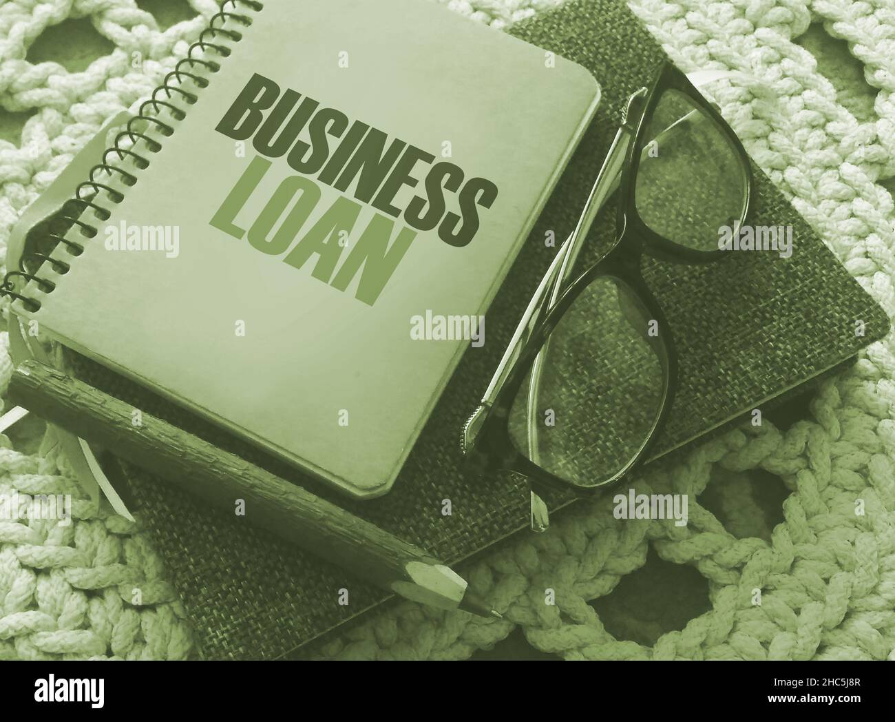Business Loan Words on the cover of notebook, glasses and pen. Business ...
