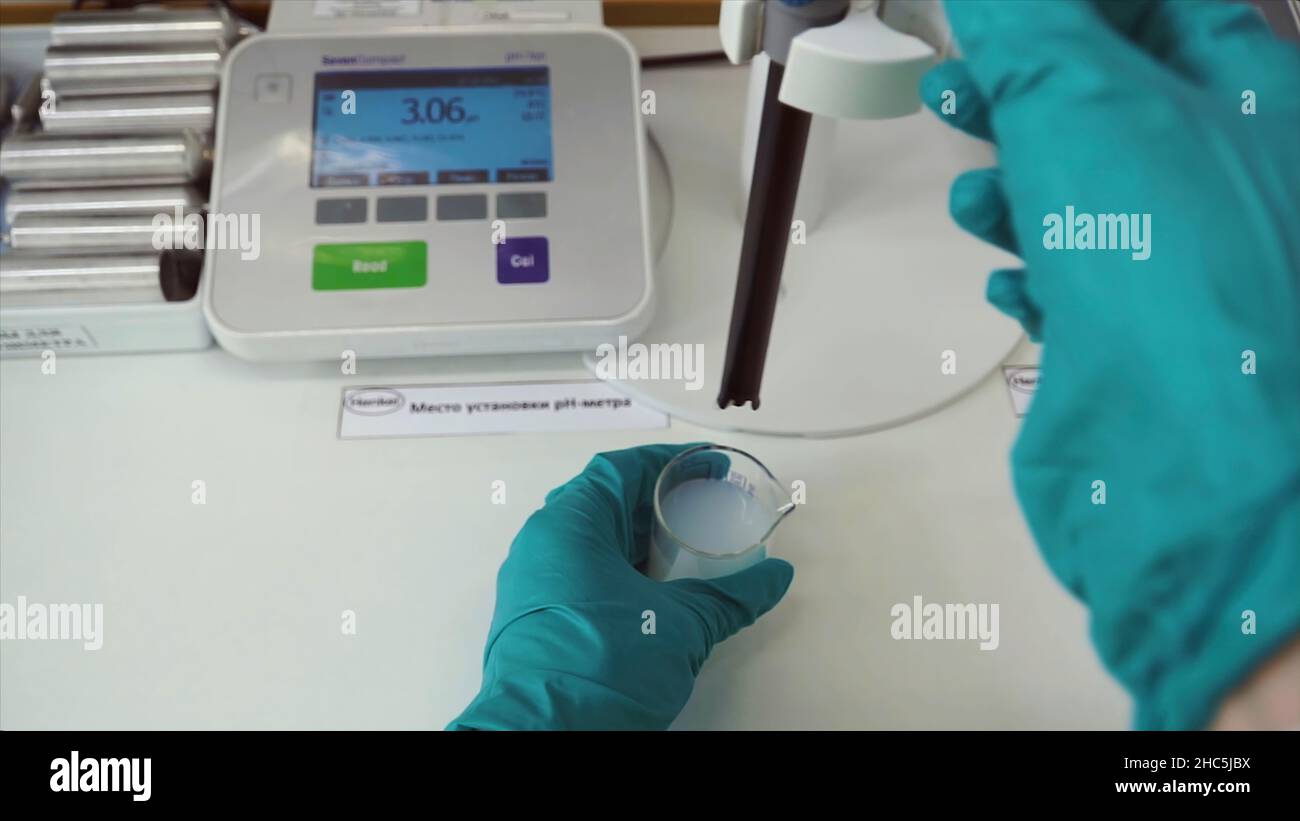 First-person view of staff working in a laboratory. Young chemical ...