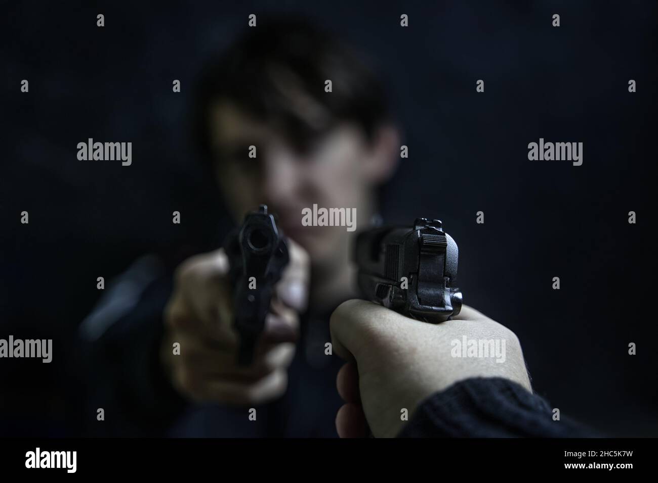 Man's hand with pistol pointed at criminal with revolver Stock Photo ...