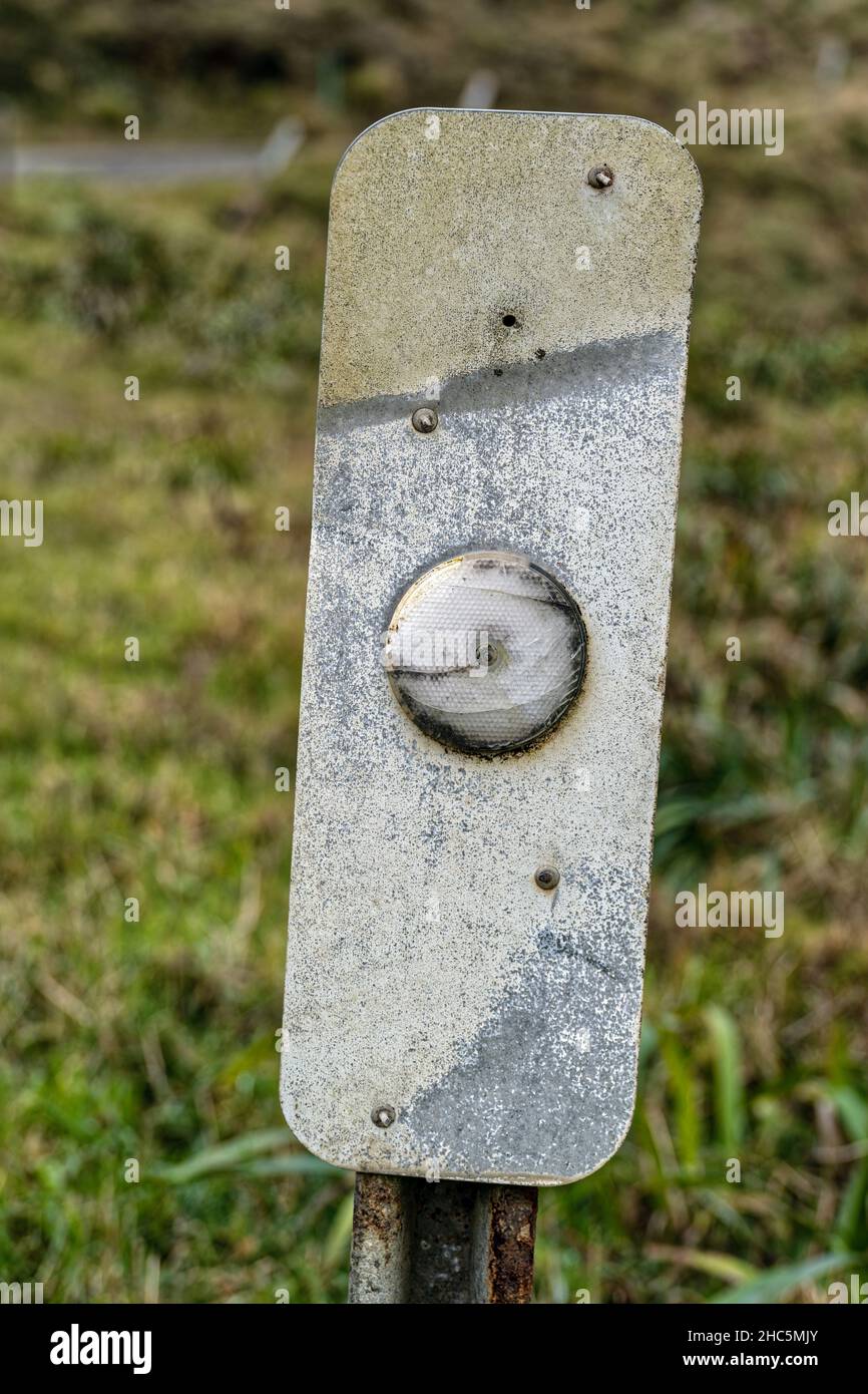 Close up view of a roadside reflector on a pole Stock Photo - Alamy