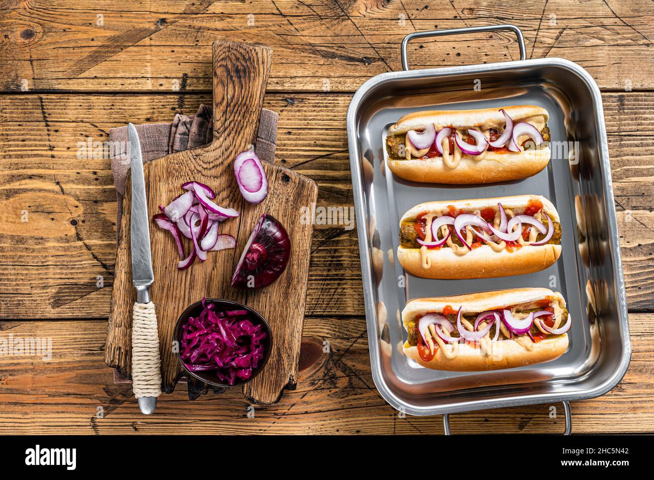 Vegan Vegetarian hot-dogs with onion and meatless sausage. Wooden ...