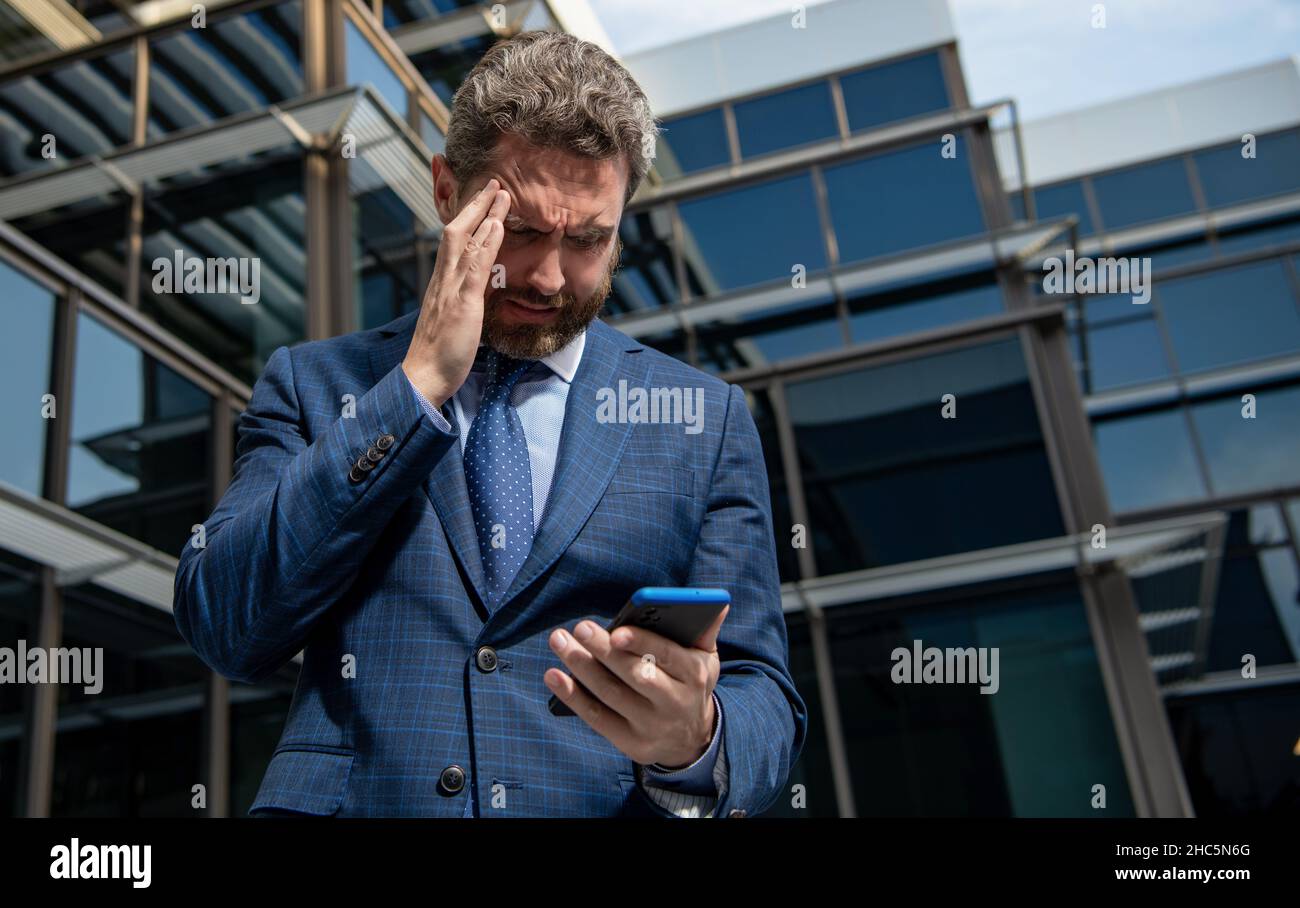 mobile connection technology. frustrated businessman hold smartphone ...
