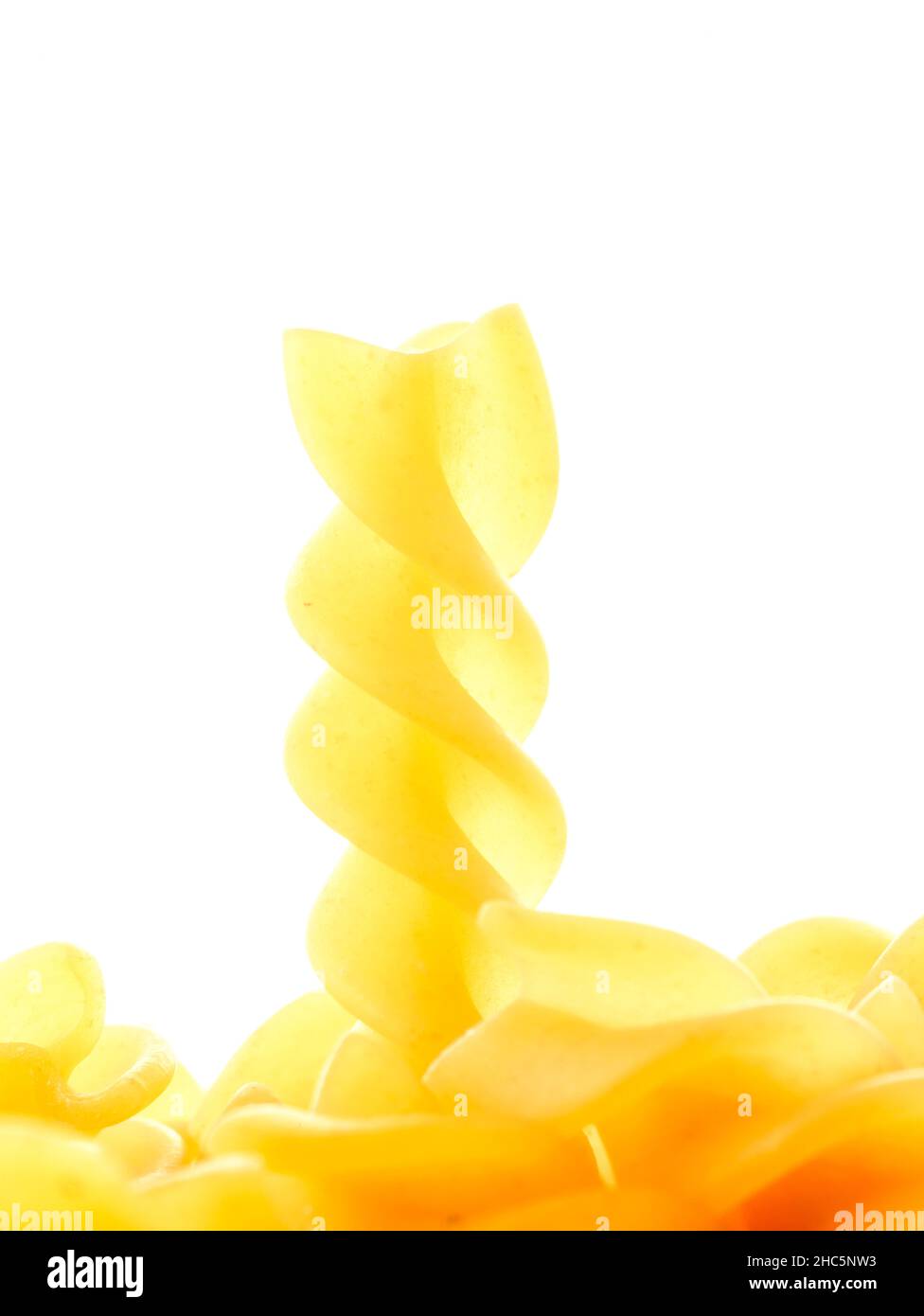 Macro food ingredient of Fusilli, fuˈzilli, pasta, against a plain bac ...