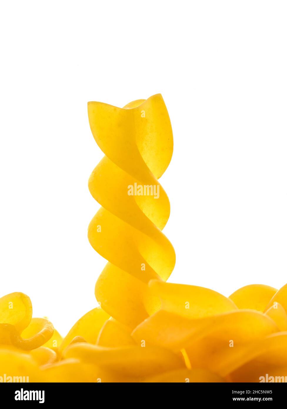 Macro food ingredient of Fusilli, fuˈzilli, pasta, against a plain bac ...