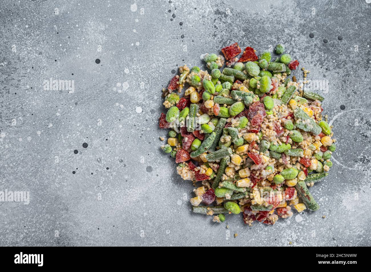 Assortment of frozen vegetables and quinoa with ice. Gray background ...