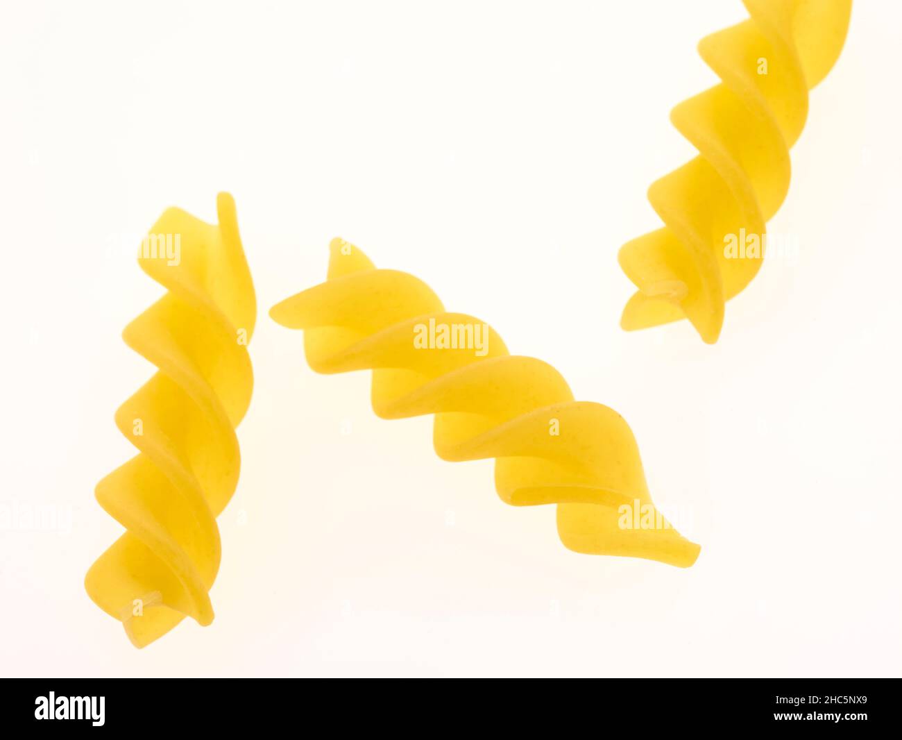 Macro food ingredient of Fusilli, fuˈzilli, pasta, against a plain ...