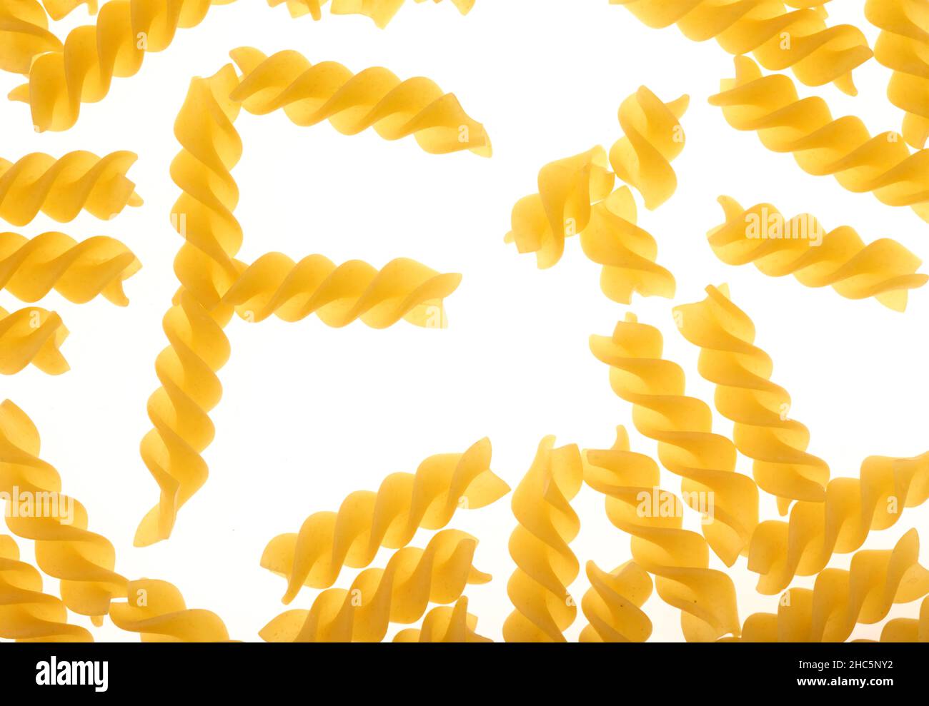 Macro food still life of Fusilli, fuˈzilli, pasta on plain background ...