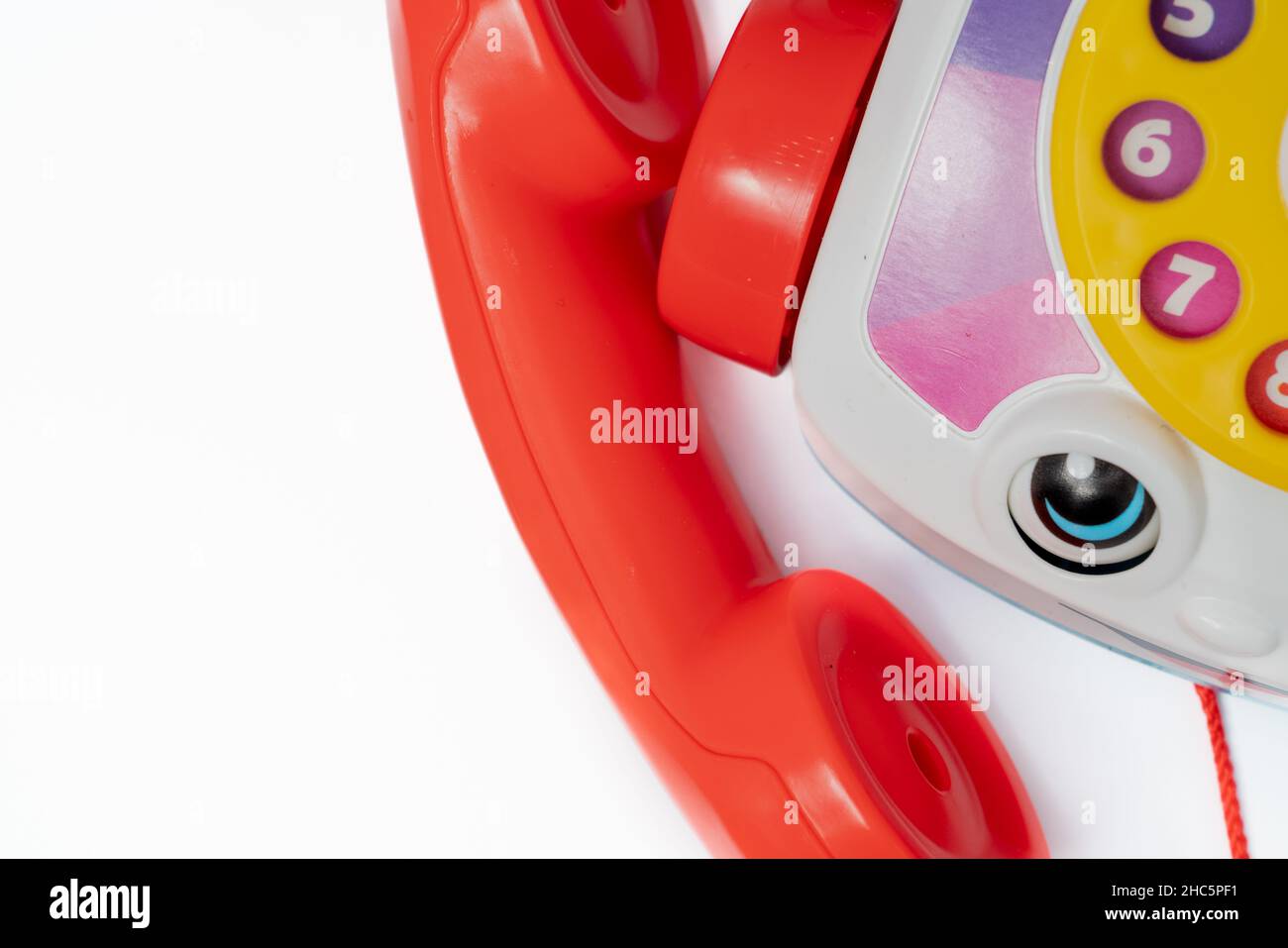 Children's toy landline phone with a red receiver, a dial and a smile ...