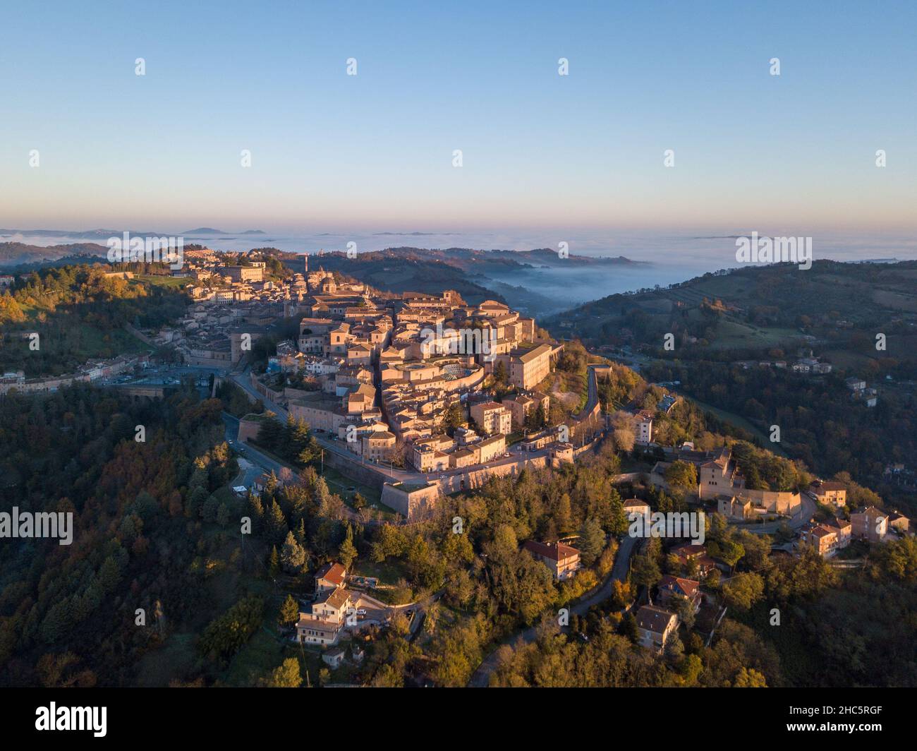Aerial view of the medieval walled city on a mountain during the day ...