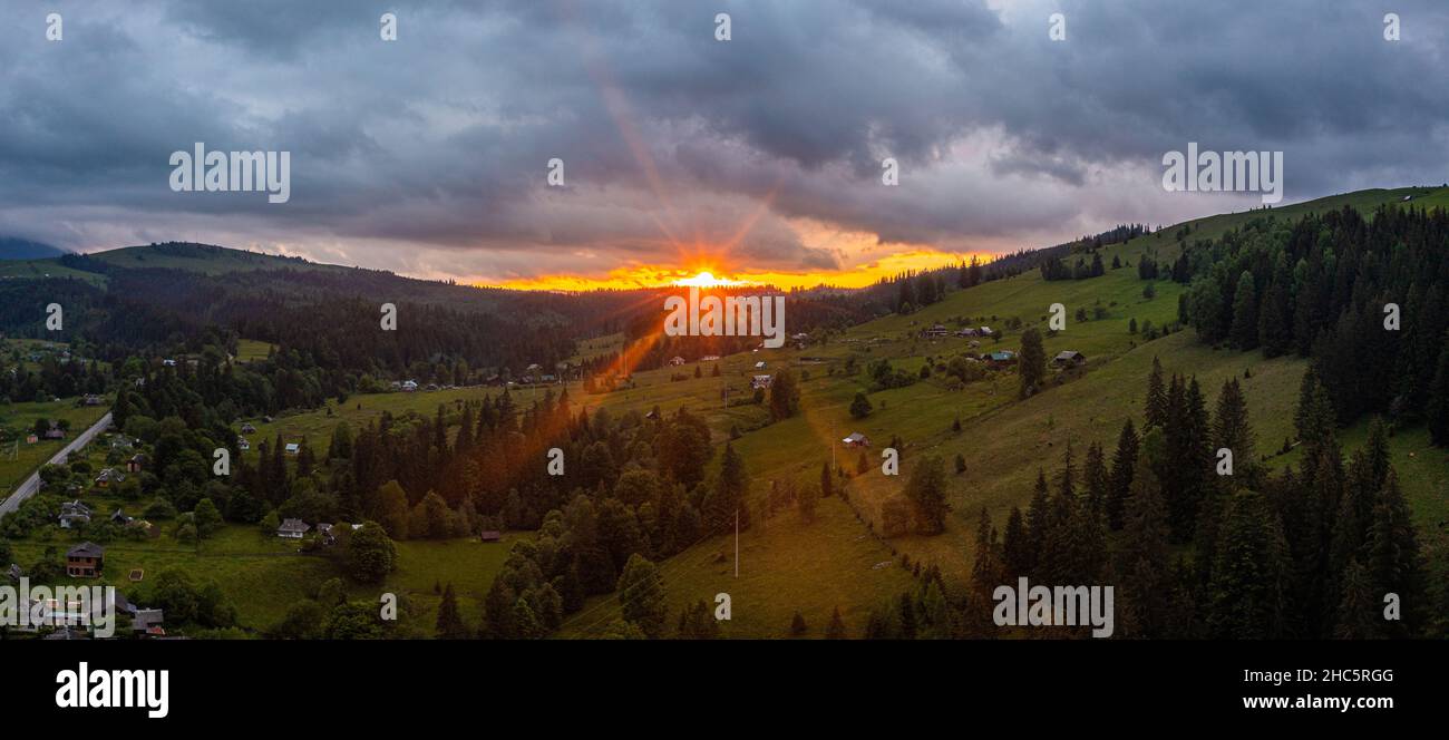 Magical sunset over the green hills and mountains Stock Photo - Alamy