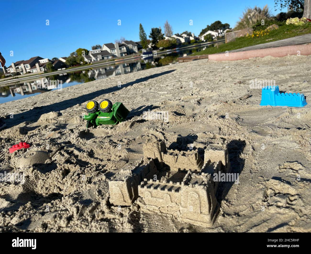 Castle made of sand and colorful toys on the beach Stock Photo - Alamy
