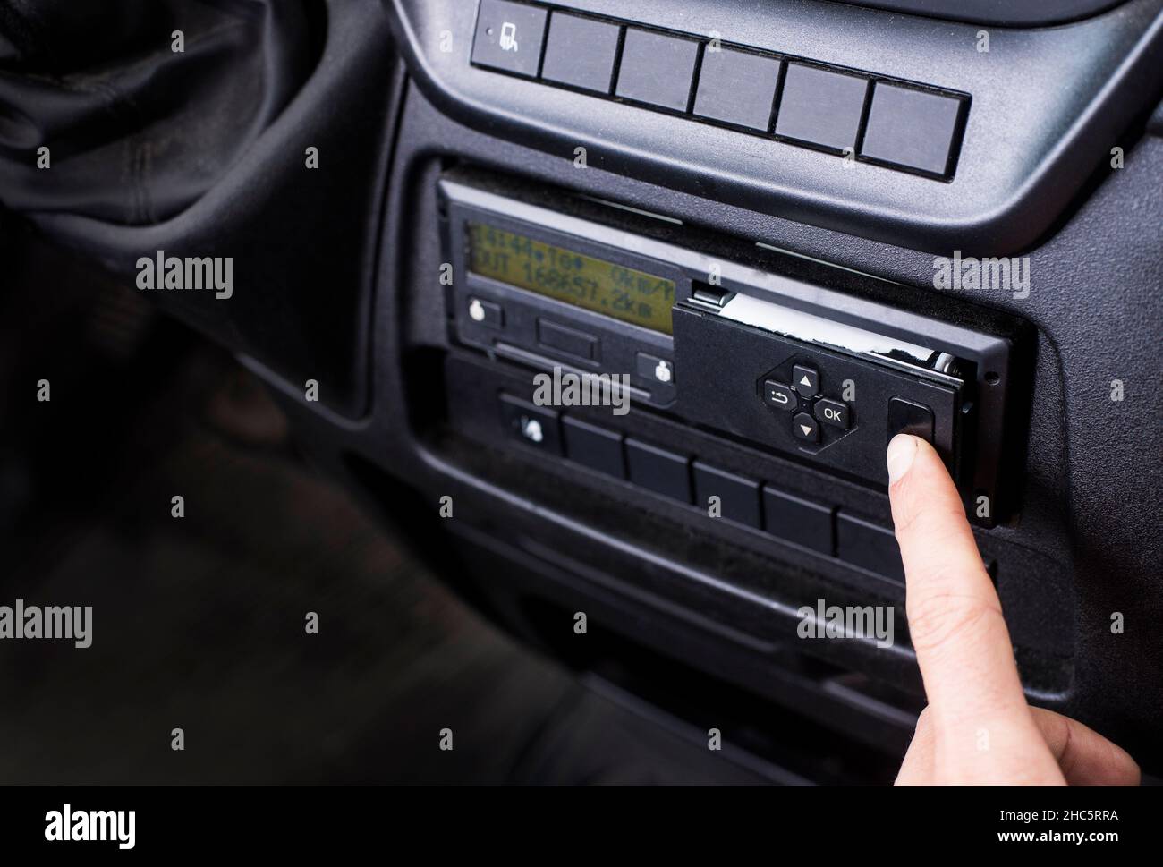 Digital tachograph with an open printer and visible roll of paper ...