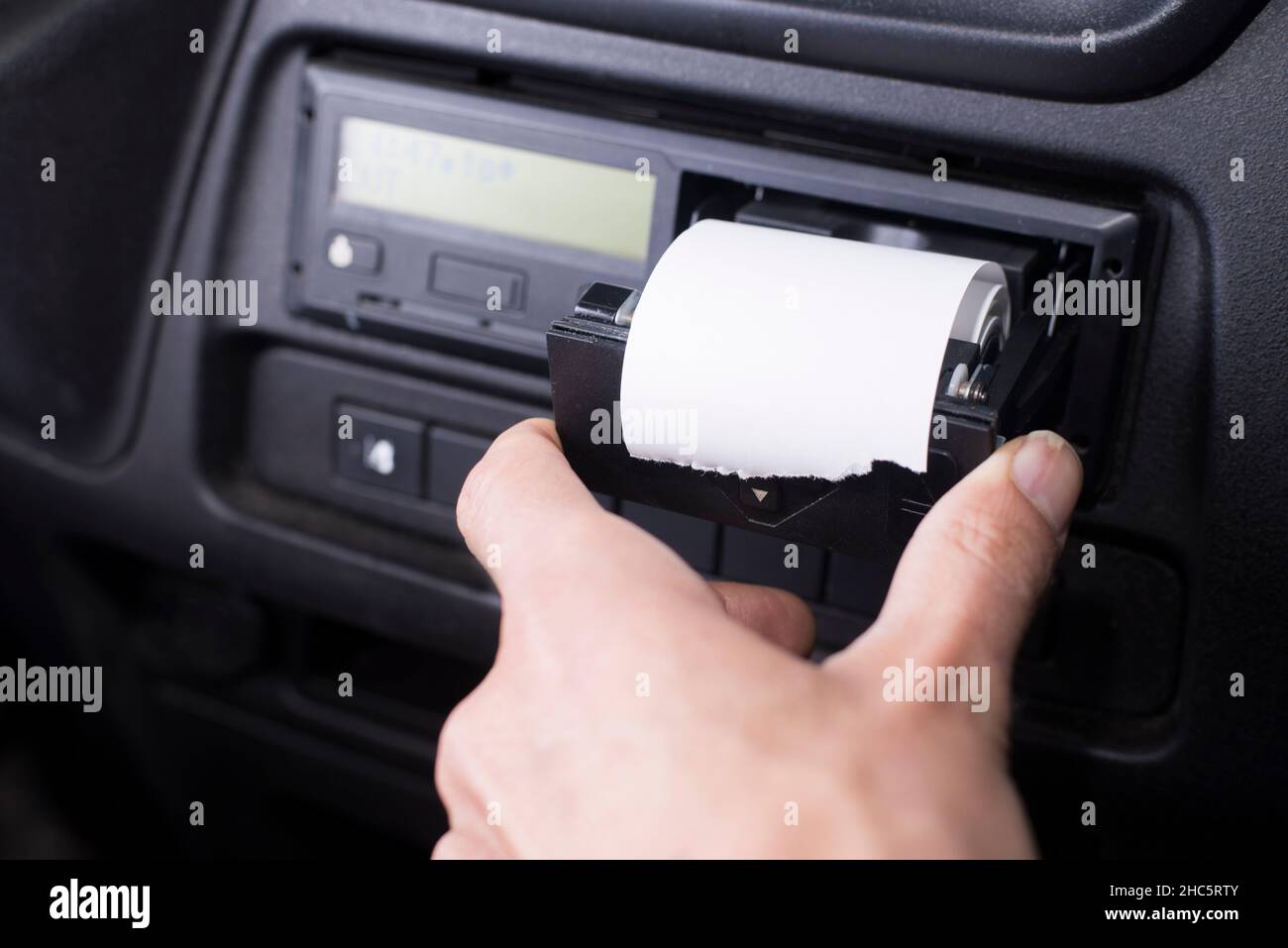 Digital tachograph with an open printer and visible roll of paper ...