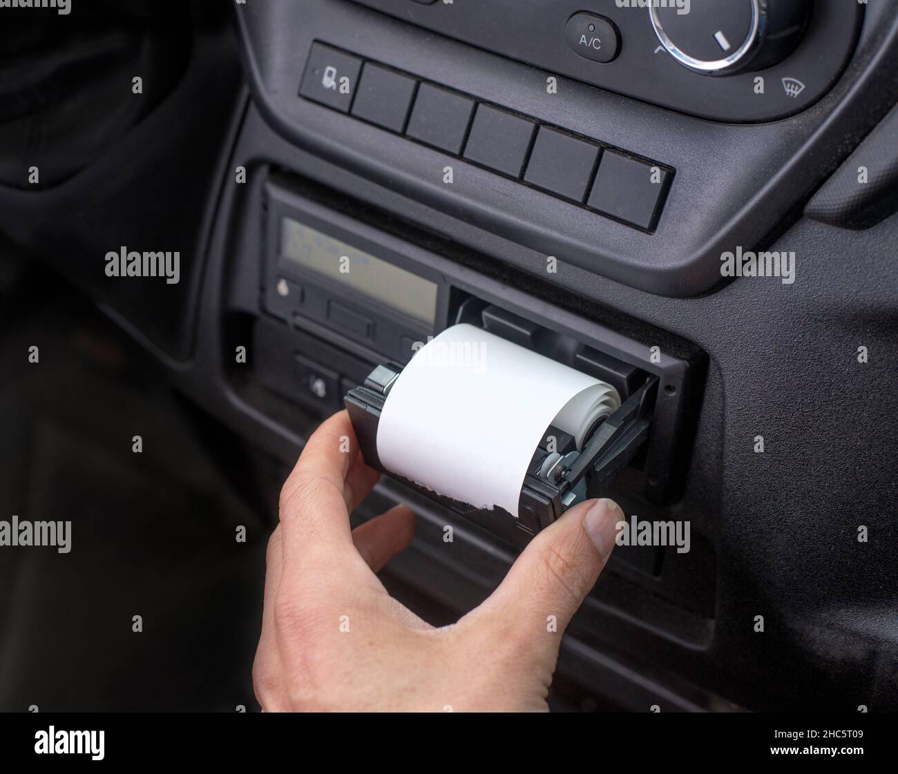 Digital tachograph with an open printer and visible roll of paper ...