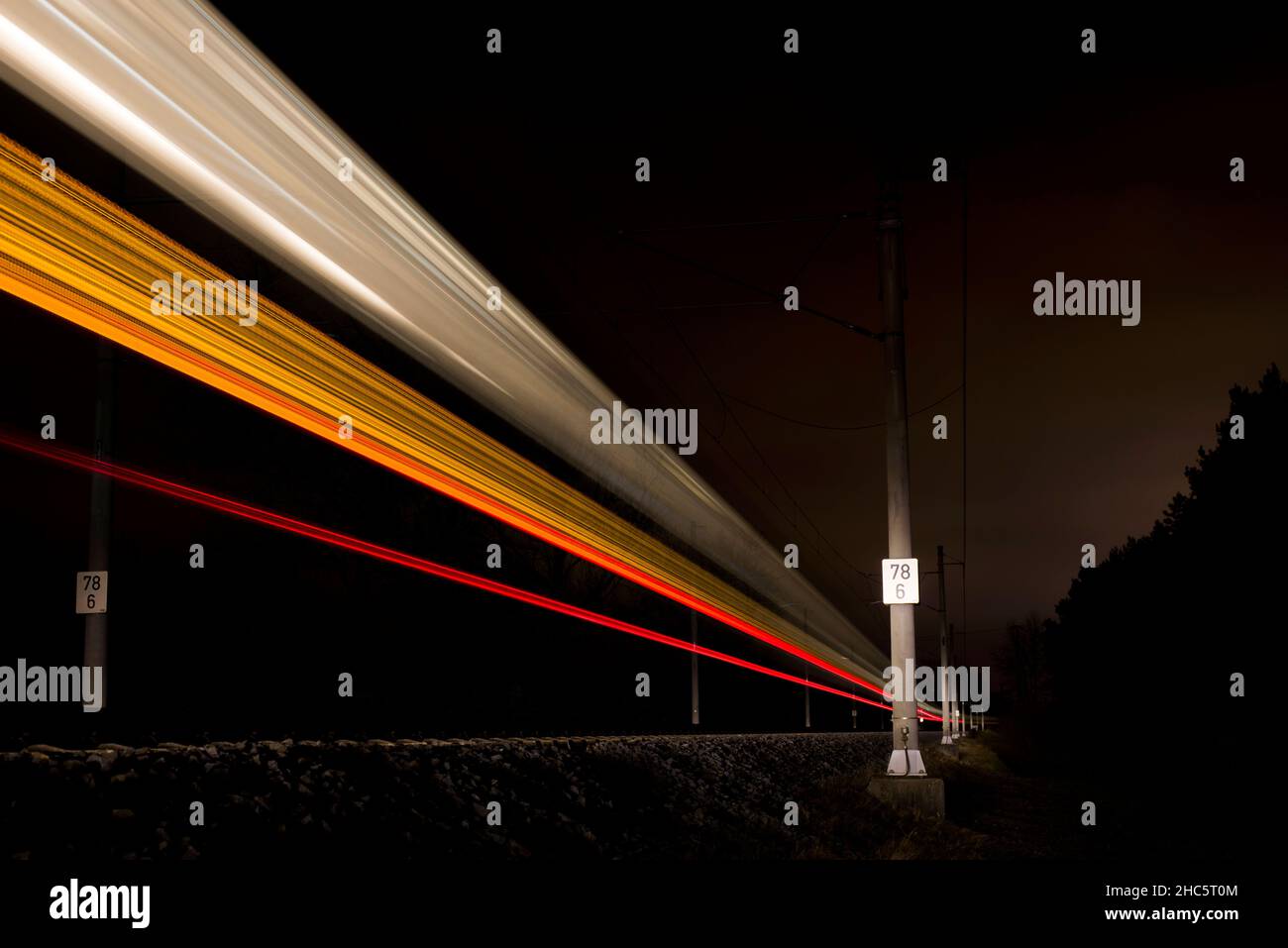 Low exposure of a train in the night railw Stock Photo - Alamy