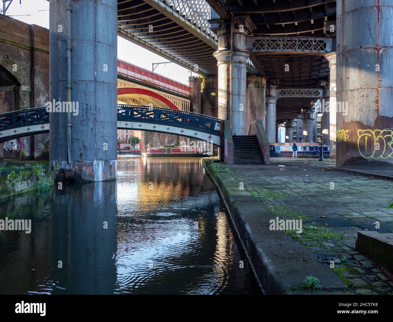 View of a canal with Victorian railway bridges above Manchester, UK ...