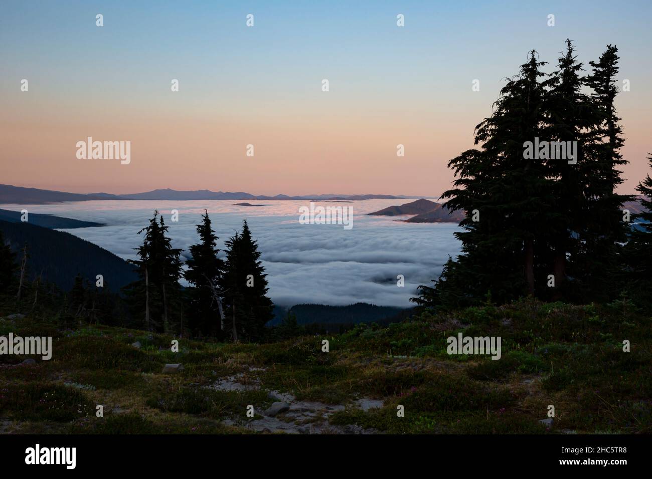 WA19923-00...WASHINGTON - Fog filled valley and a smoky sunrise viewed ...