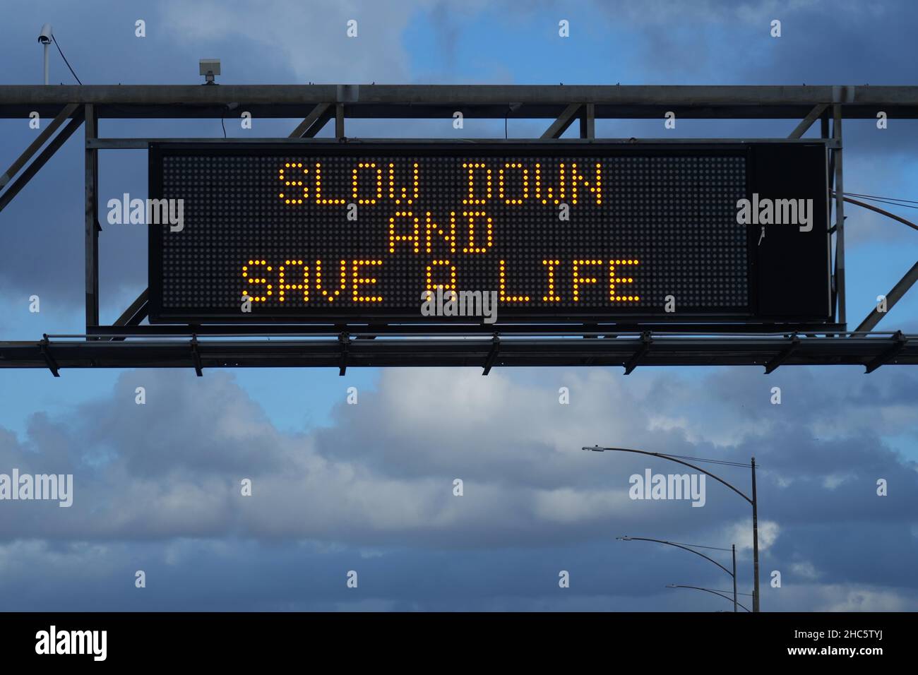 A Caltrans message board with the words "Slow Down. Save a Life" is ...