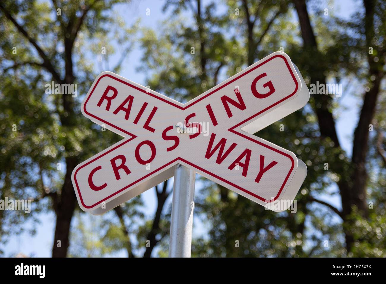 Sign-warning saying "crossing railway" with a blurred background Stock ...
