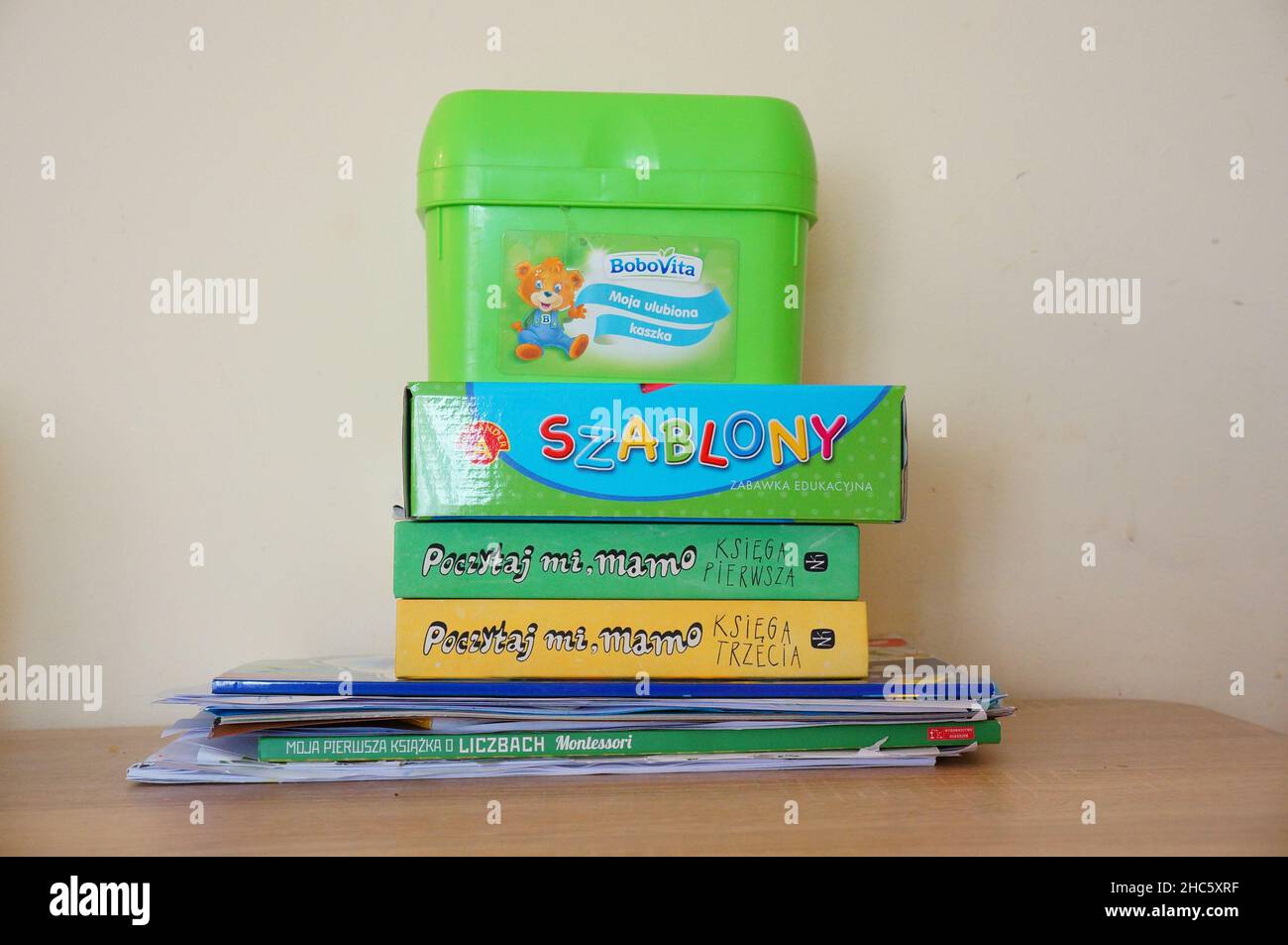 Pile of board games and books for kids on a wooden table Stock Photo ...