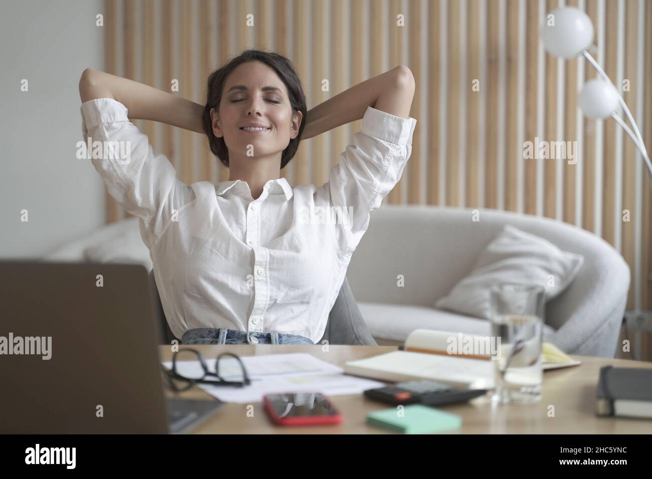 Freelancer lady sitting in front of laptop in relaxed position, eyes ...