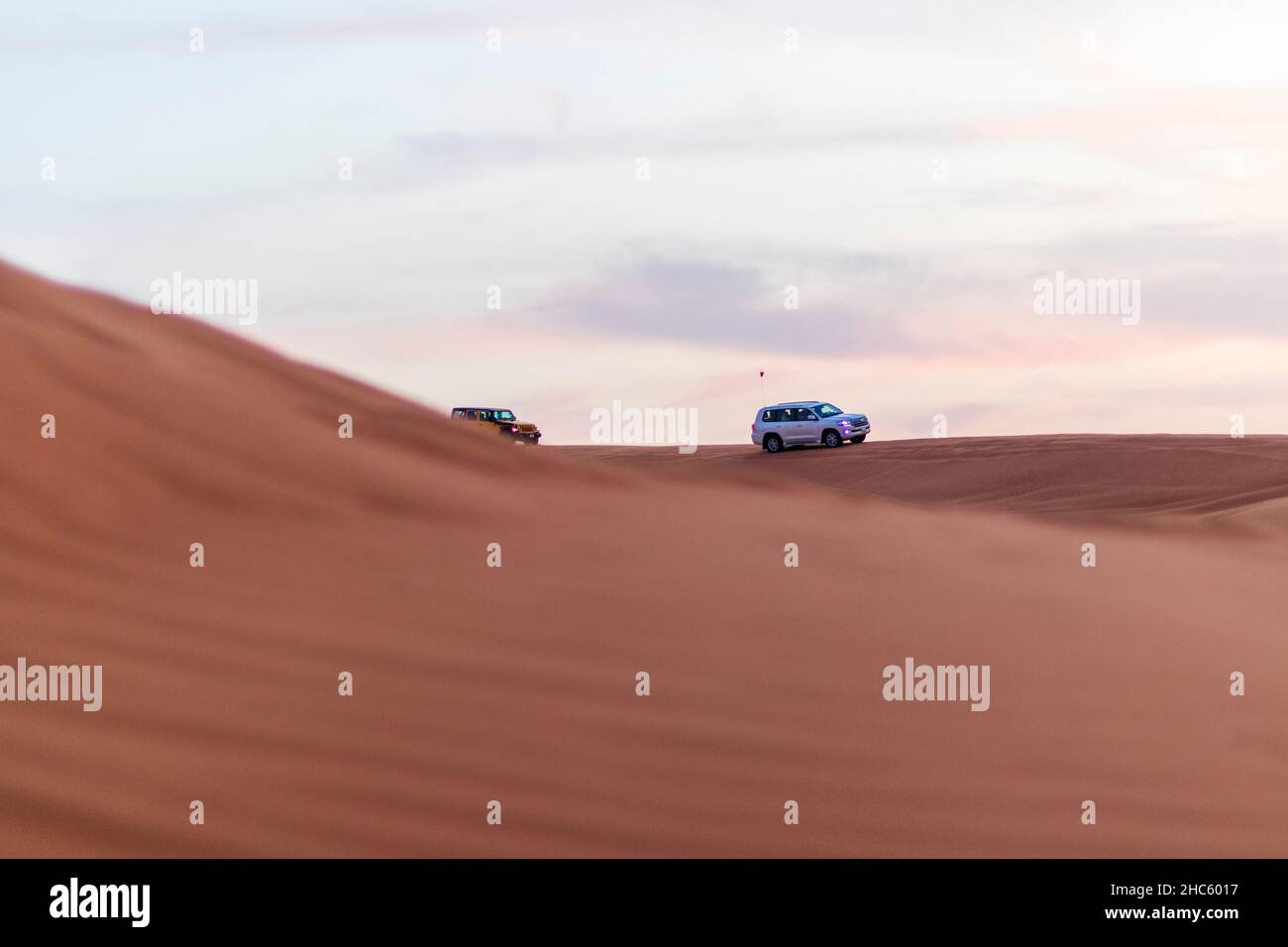 Shot of a SUV vehicle driving trough sand dunes Stock Photo - Alamy