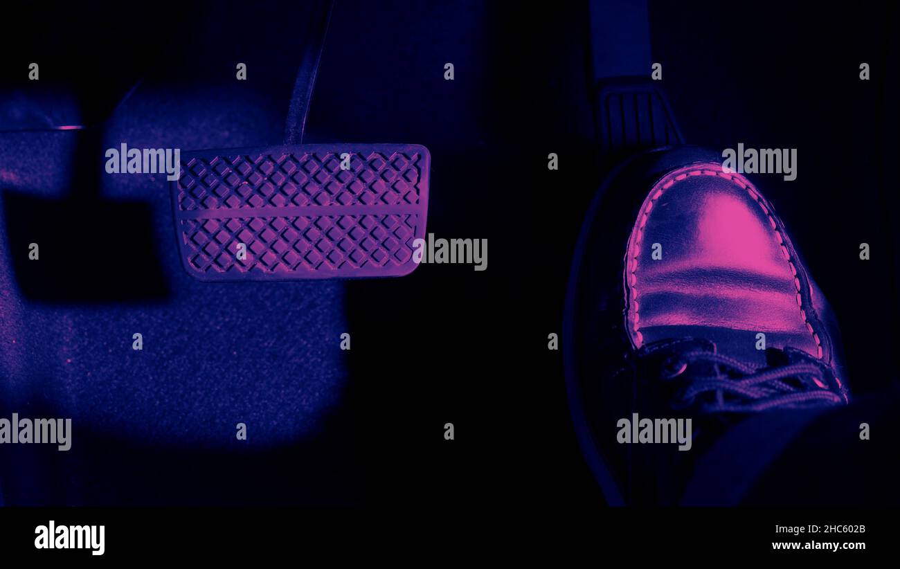 Accelerator and breaking pedal in a car. Close up the foot pressing ...