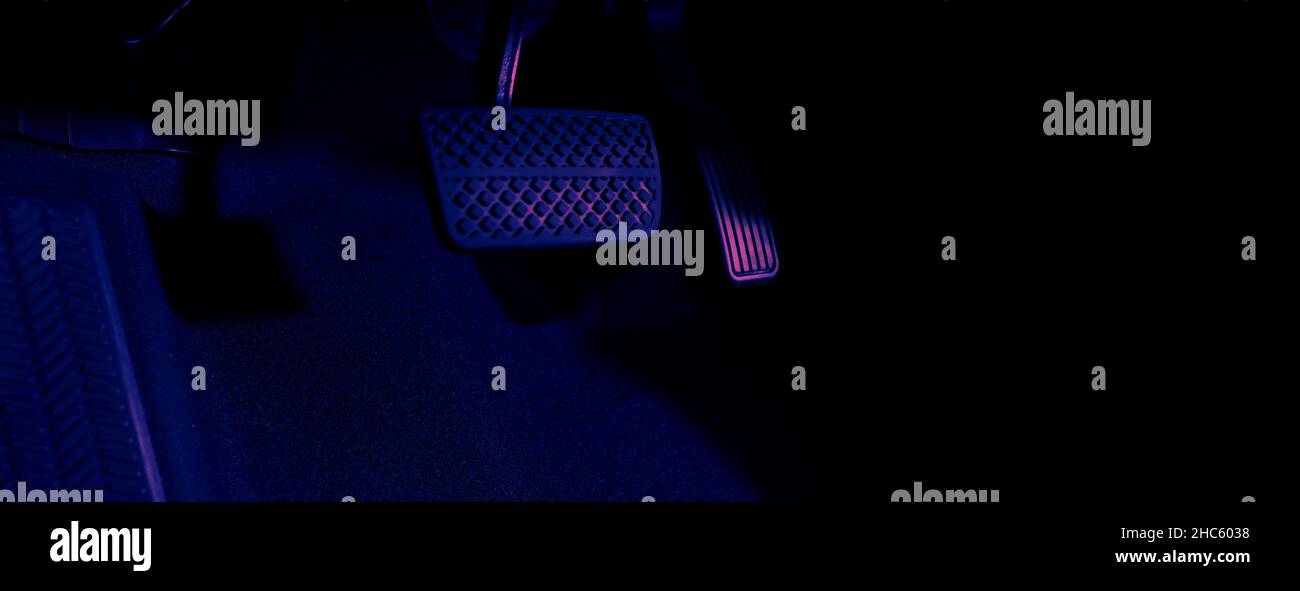 Accelerator and breaking pedal in a car. Close up the foot pressing ...