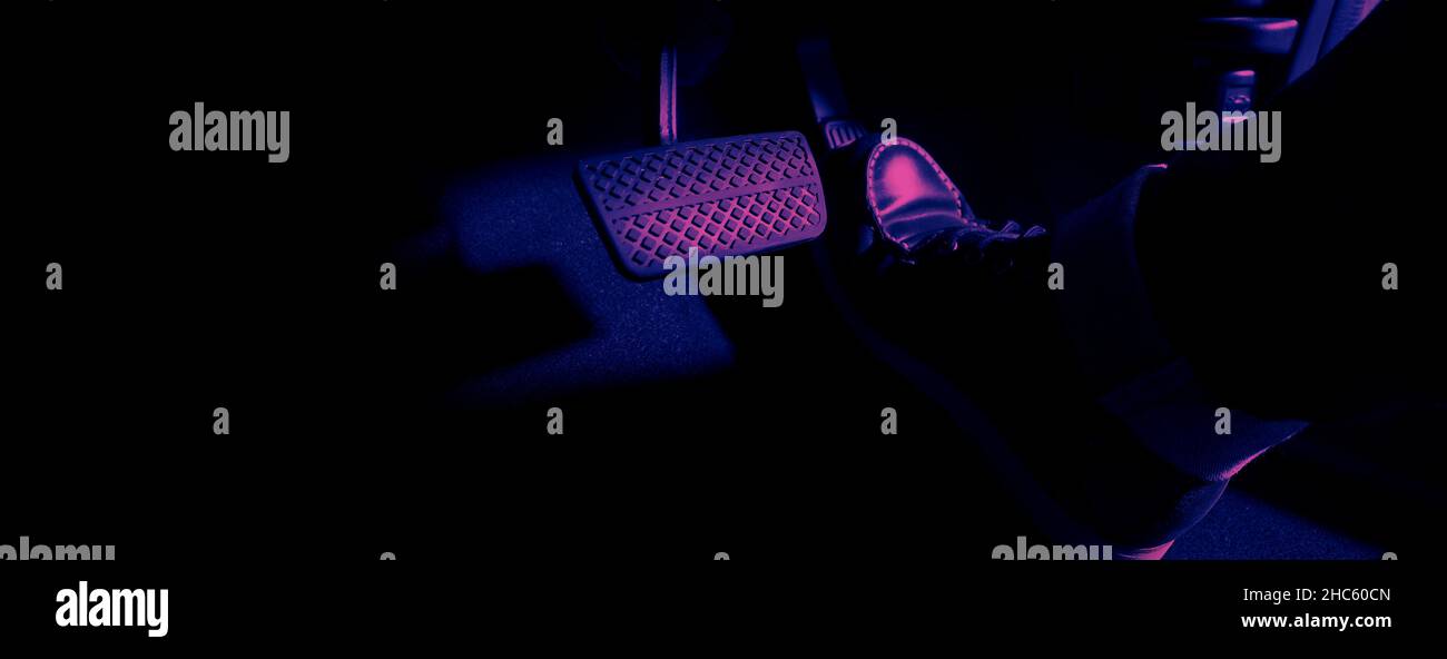 Accelerator and breaking pedal in a car. Close up the foot pressing ...
