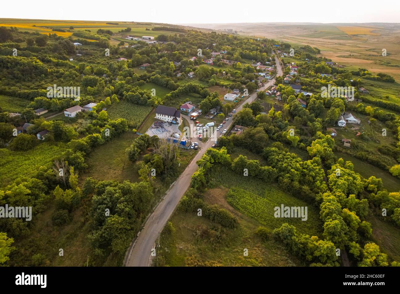 Aerial view of the country road, houses, and a vast landscape in the ...