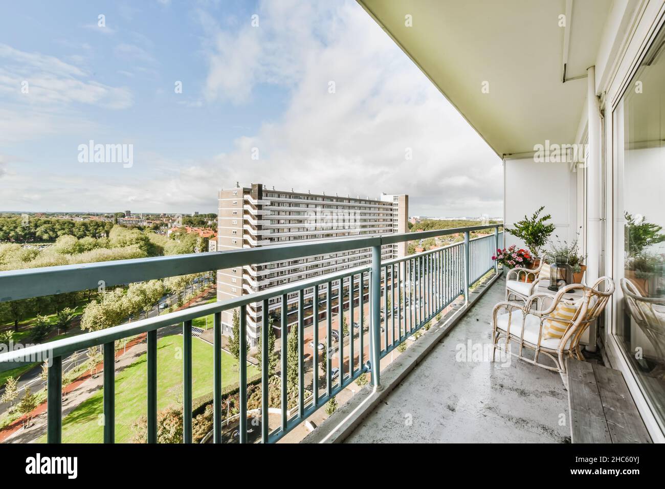 Long narrow balcony design with comfortable armchair Stock Photo - Alamy