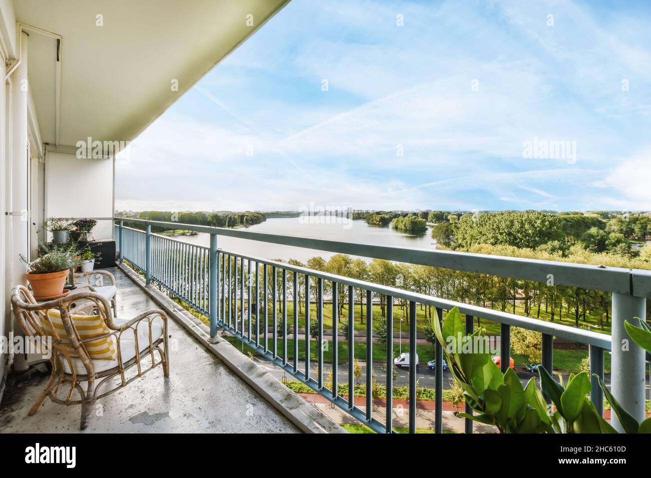 Long narrow balcony design with comfortable armchair Stock Photo - Alamy
