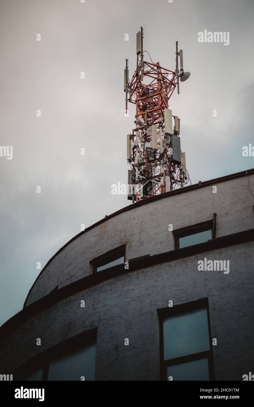 Telecom tower behind the building Stock Photo - Alamy