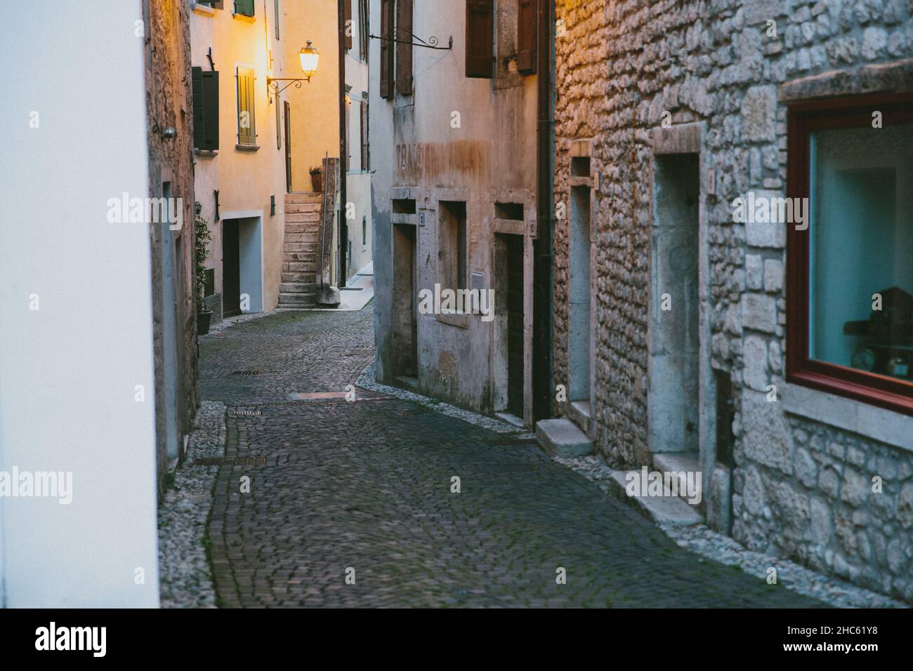 Path between aged houses Stock Photo - Alamy