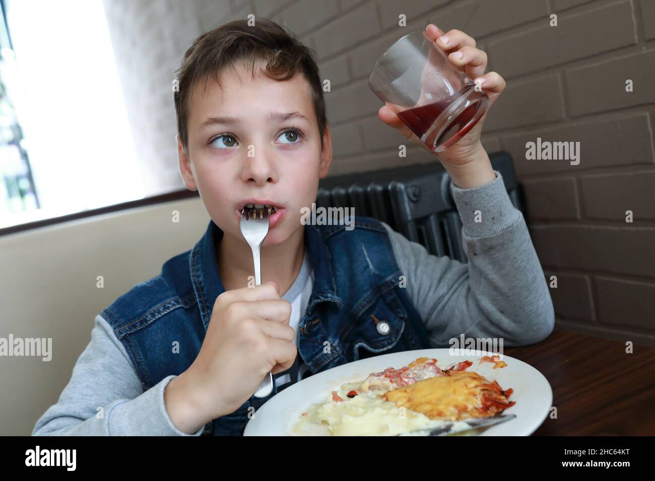 Kid eating french meat with potatoes in restaurant Stock Photo - Alamy