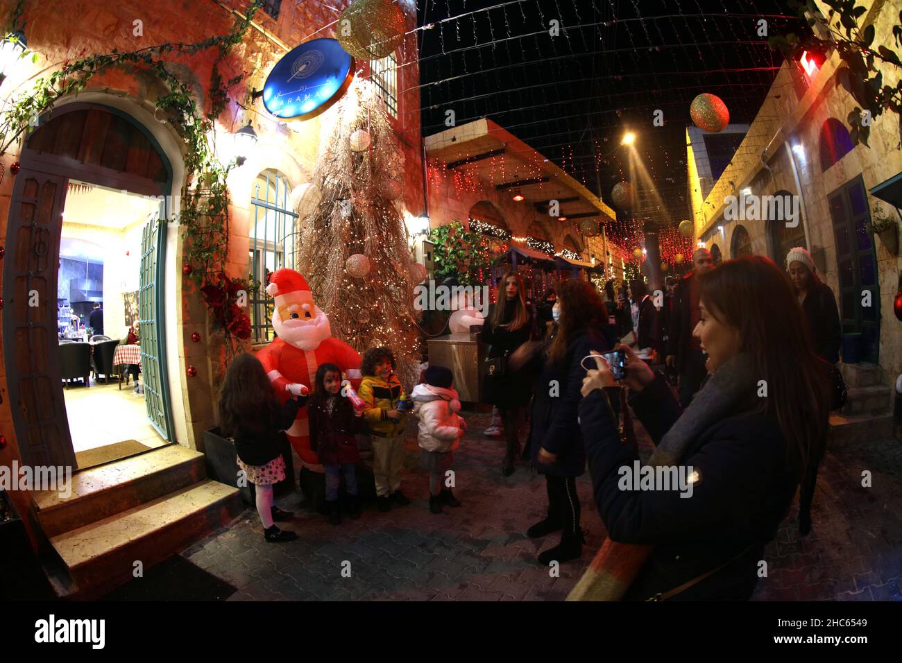 Amman, Jordan. 24th Dec, 2021. People pose for photos at a Christmas ...