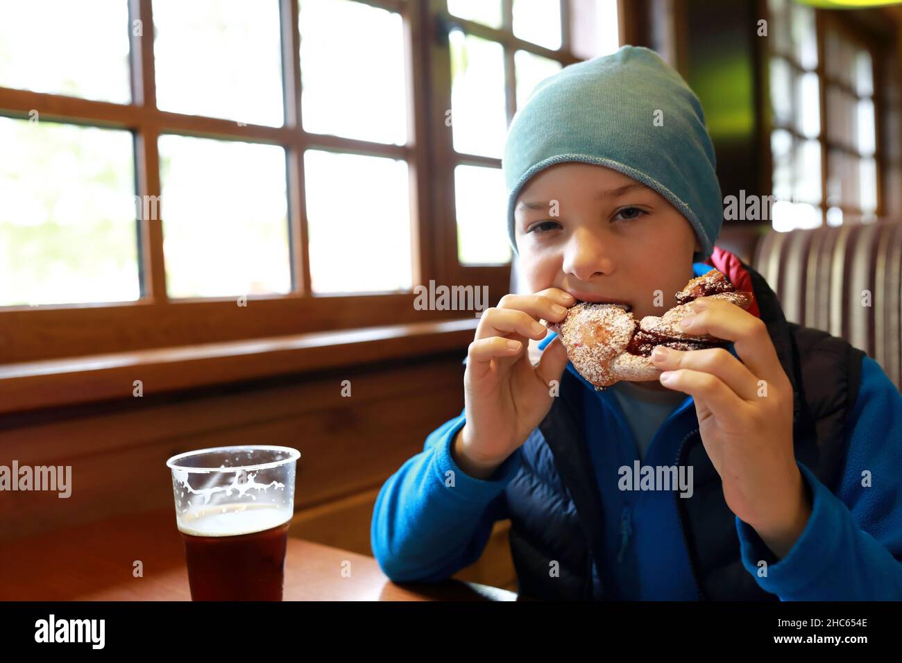 Portrait boy eating sweet bun hi-res stock photography and images - Alamy