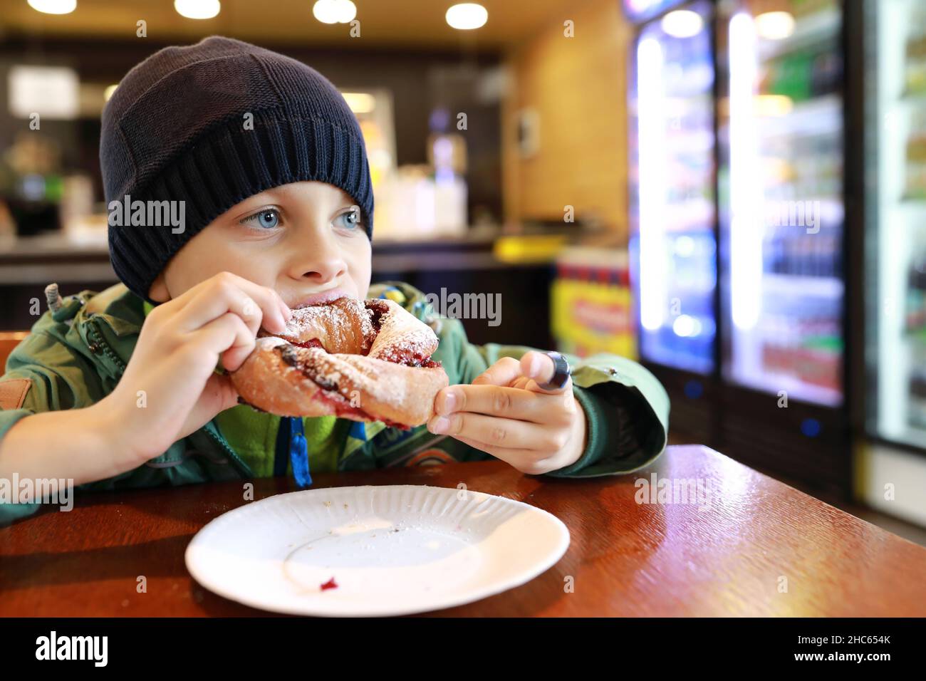 Boy eating braided bun with jam in restaurant Stock Photo - Alamy