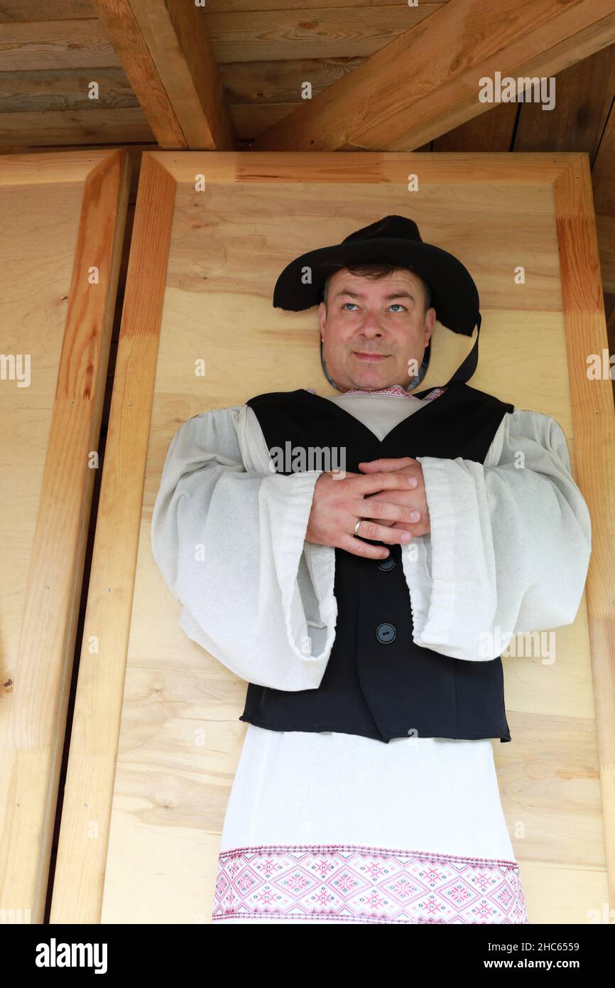 Portrait of man posing face in hole board of Finnish folk Stock Photo ...
