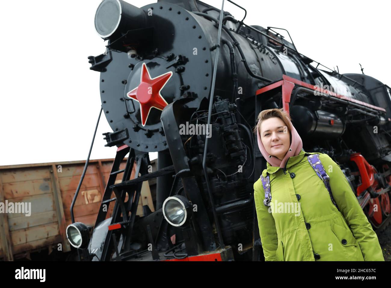 Woman on background of steam locomotive at railway station Stock Photo ...