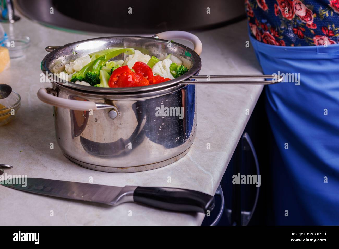 chopped boiled vegetables in colander in stainless steel cooking pot ...