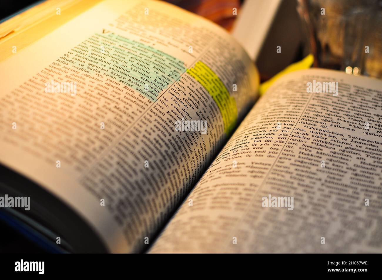 Closeup of an open book with text highlighted in yellow and blue Stock ...