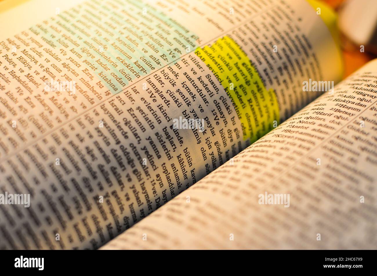 Open book with paragraphs highlighted in yellow and blue Stock Photo ...