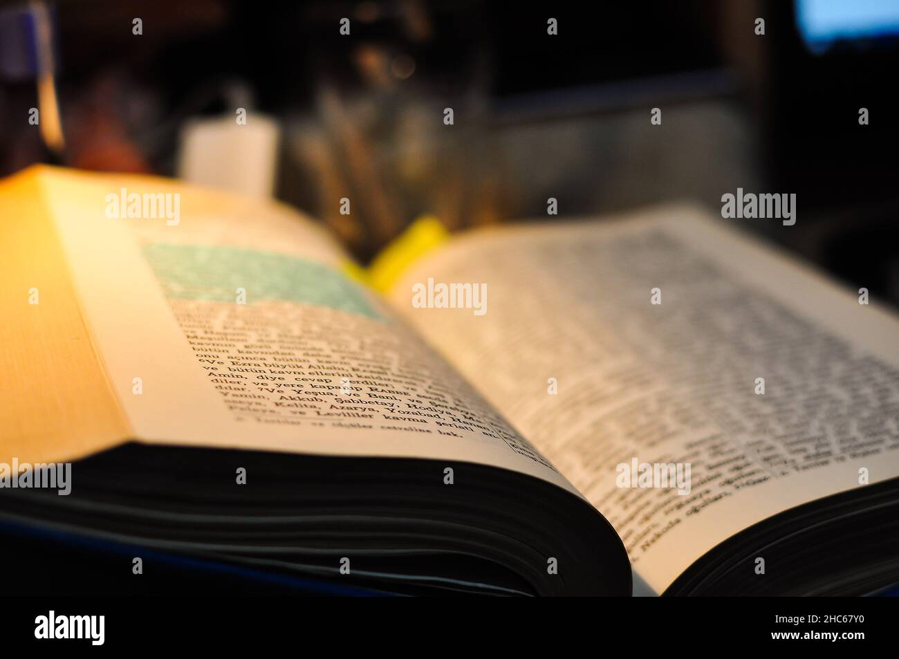 Selective focus shot of an open book with a blue-highlighted paragraph ...