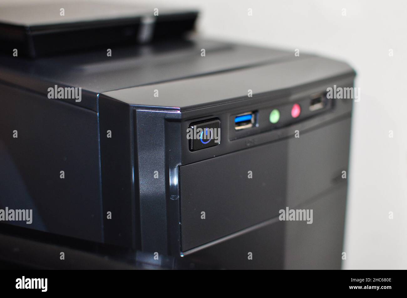 Black computer case with a blue power button Stock Photo - Alamy