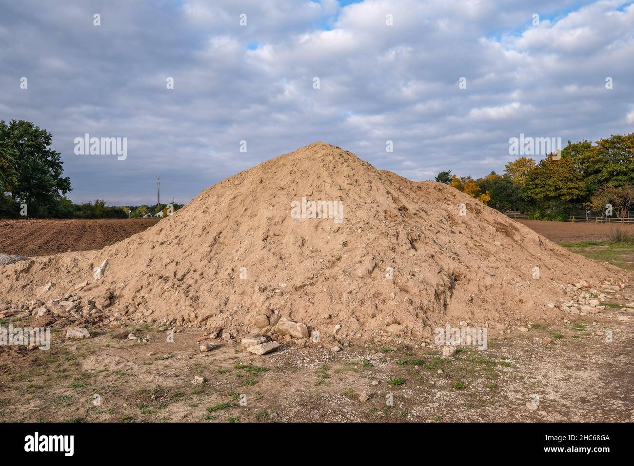 Big sand waste in the middle of a field in the daytime Stock Photo - Alamy